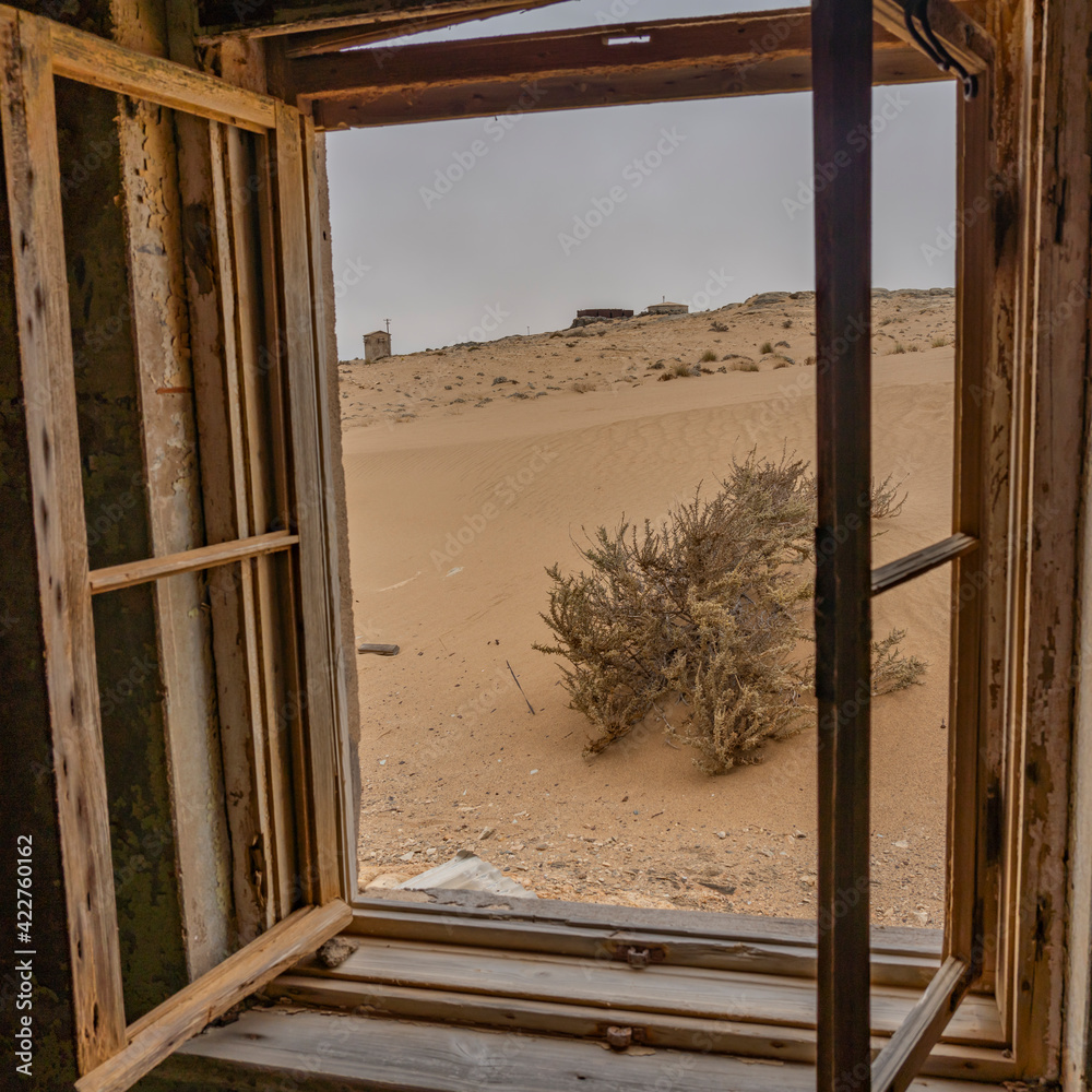 View out of a window at German Kolmanskop Ghost Town with the abandoned ...