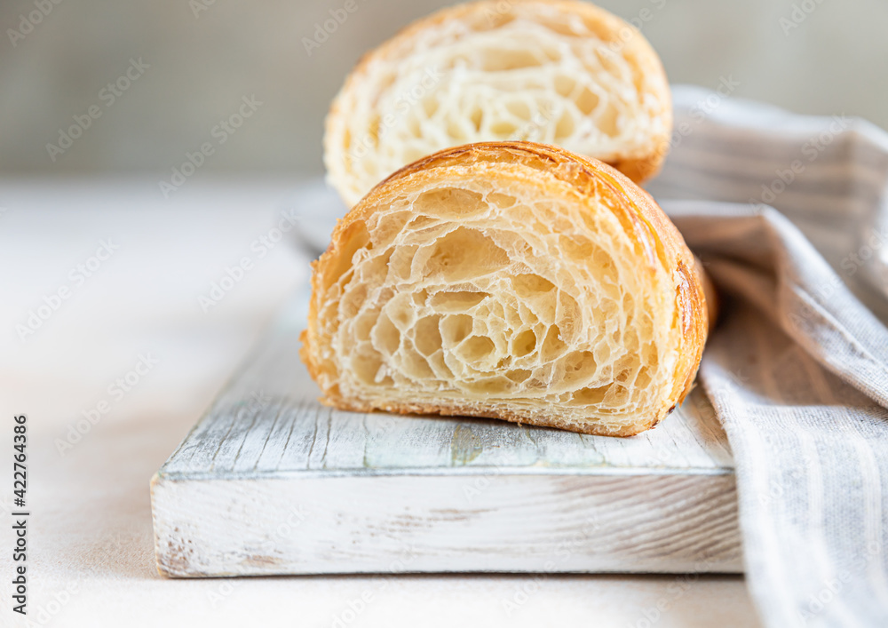 Cut in half croissant with inside texture and thin crisp layers on ...