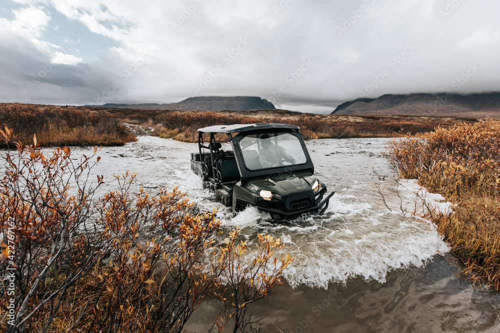quad bike atv crossing a river in Alaska hunting autumn time in alaska ...