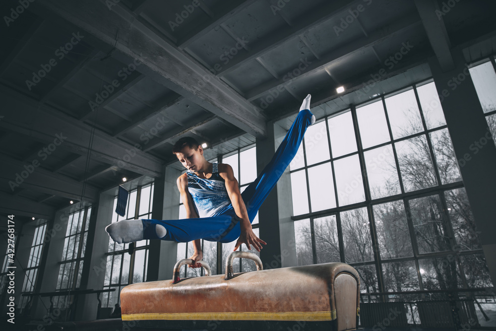 Little male gymnast training in gym, flexible and active. Caucasian fit ...