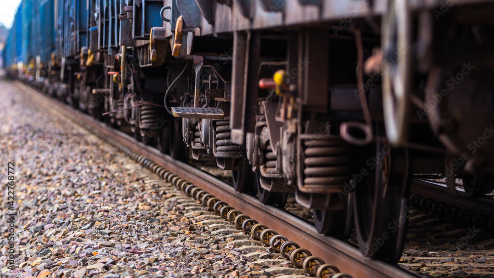 Trolleys and wheels of cargo train . Photo taken in low light ...