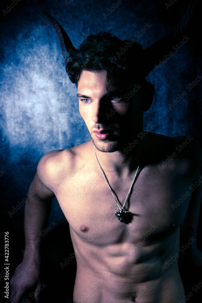 Sexy shirtless male devil with horns and muscular body showing pecs and ...