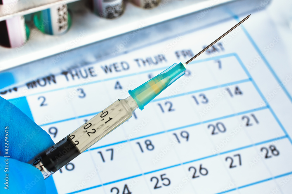 Doctor holding a syringe with a 0.3ml load of vaccine to administer to ...