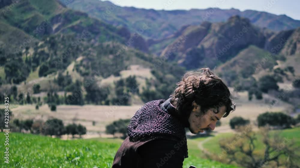 Man in medieval outfit walking forward, crouching and checking the ...