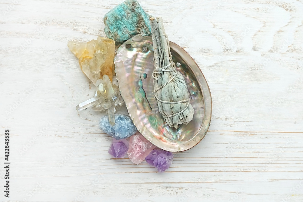 Gemstones minerals and white sage bundle on abalone shell. holy sage ...