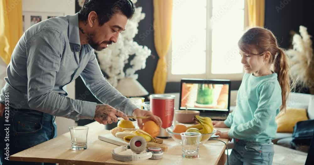 Daughter gives Dad fruit to prepare the fruit juice in the morning. Dad ...