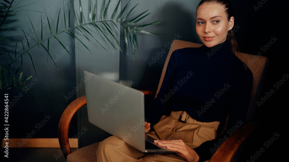 Works on a laptop computer and surfs the Internet. Close portrait of a ...