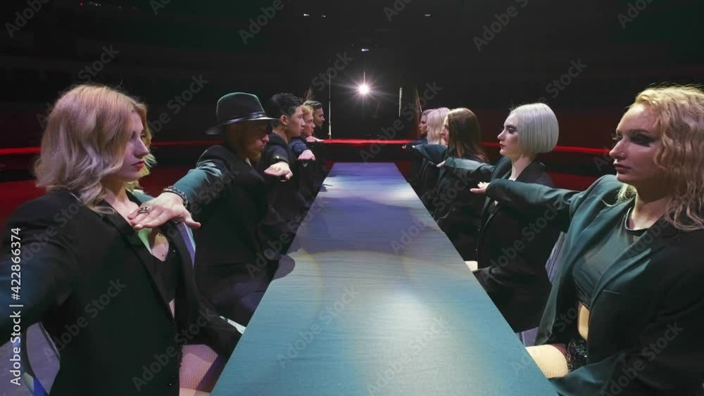 Group sectarian people strange dancing at table robotic hands movement ...