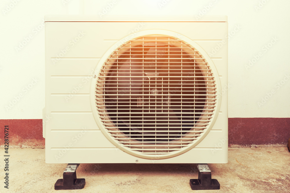 Condenser unit or compressor outside home or residential building. Unit ...