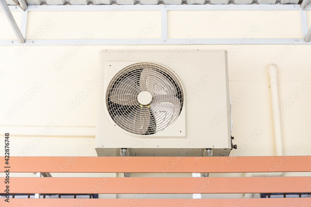 Condenser unit or compressor outside home or residential building. Unit ...