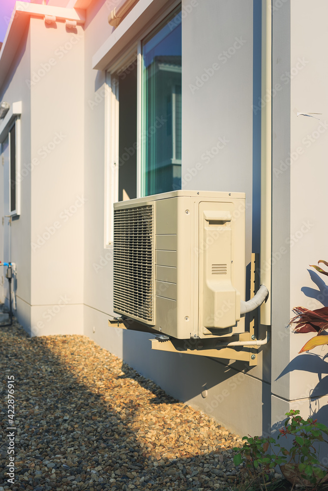 Condenser unit or compressor outside home or residential building. Unit ...
