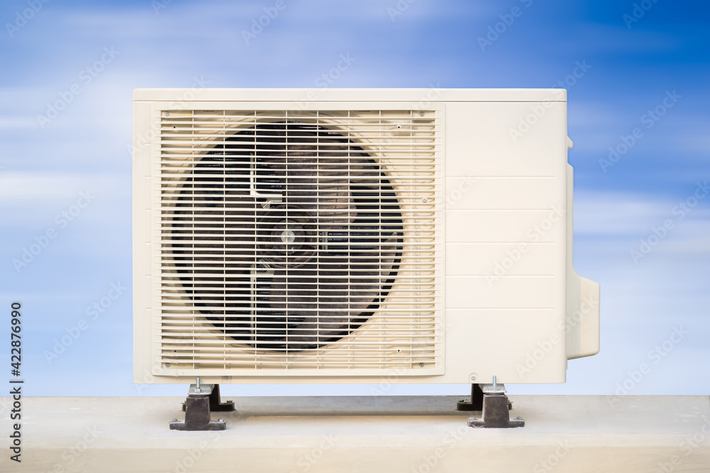 Condenser unit or compressor on roof of industrial plant building with ...