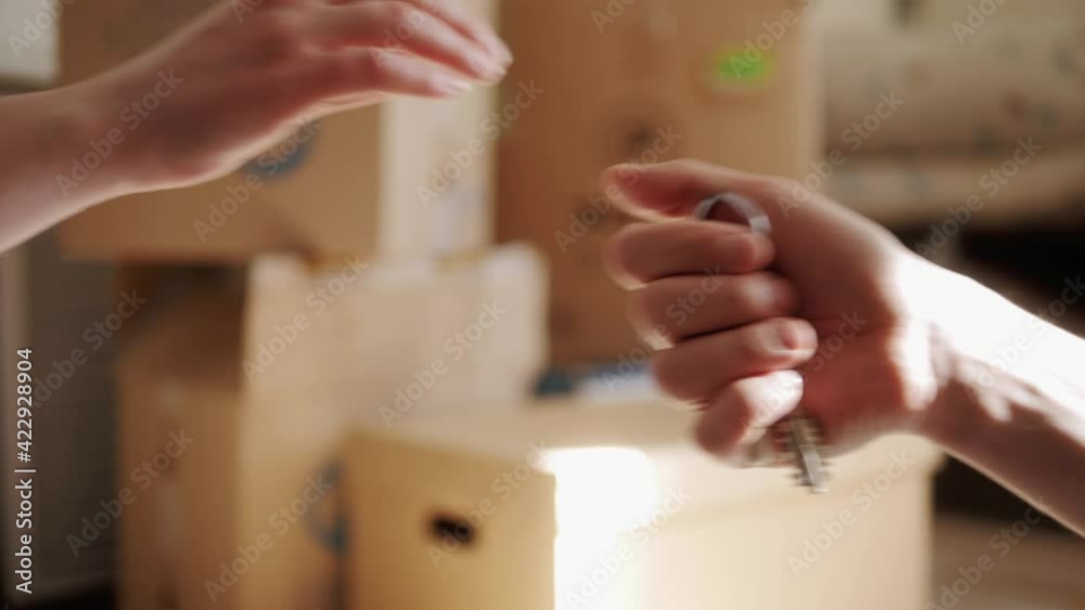 Close up of estate agent hand passing key to new owner of apartment ...