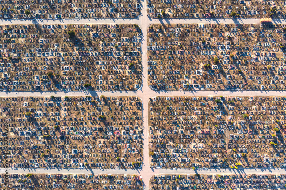 Aerial view of huge urban cemetery with grid layout. Increase in the ...