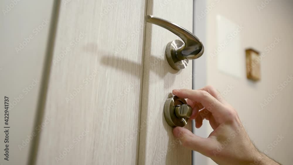 Male's hand screws on decorative glossy lids of a round shape for the ...