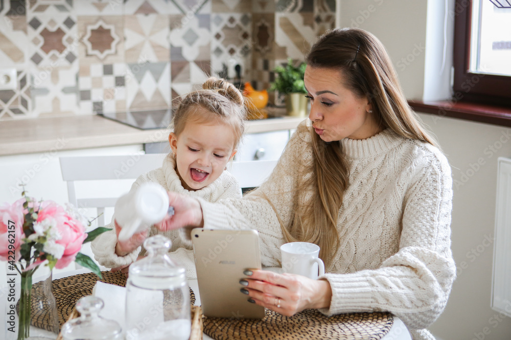 miling mother takes selfie with cute daughter on tablet, happy young ...