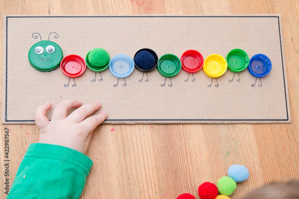 Plastic bottle caps worm. Put correct color pom poms in centipede ...