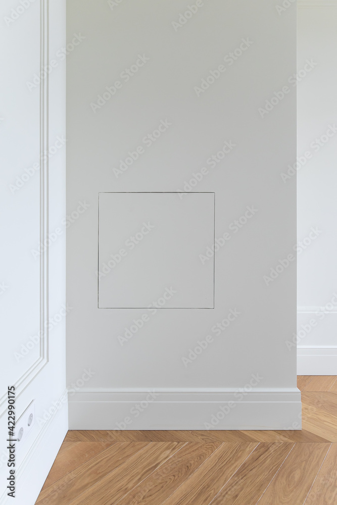 Hidden plumbing hatch in the classic interior with herringbone parquet ...