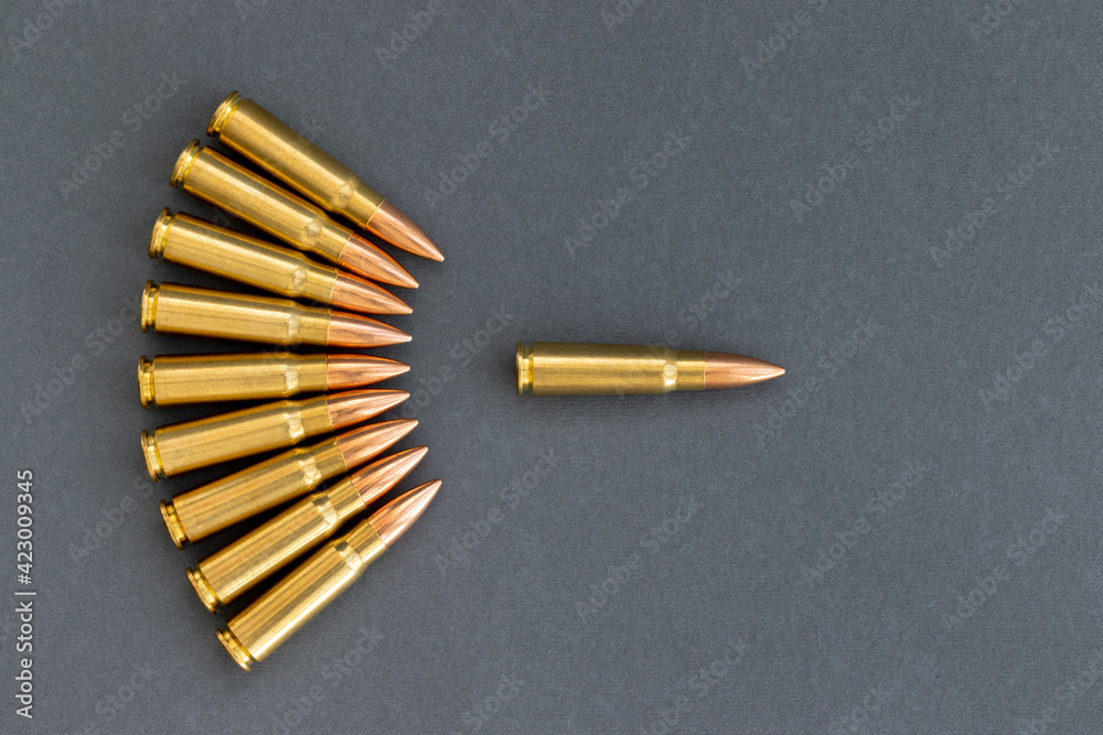 Bullets on gray paper background, one bullet ahead of the rest ...