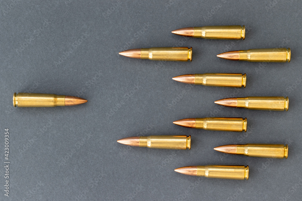 Bullets on gray paper background, one bullet in front of the others ...