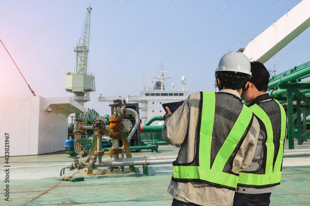 Workers on deck oil tanker ship during ship repair and maintenance in ...