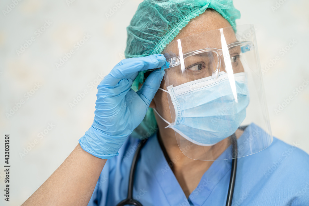 Asian doctor wearing face shield and PPE suit new normal to check ...
