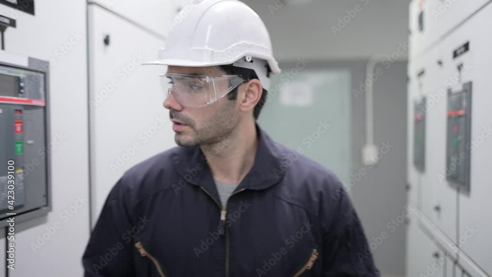 Engineer woking in Electrical room walking throw MDB (Main Distribution ...