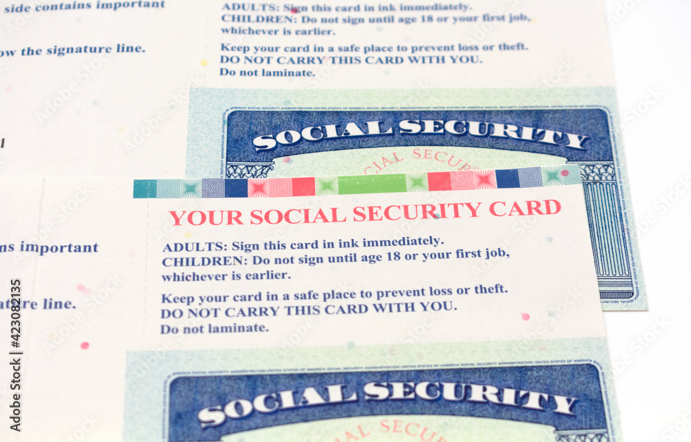 Selective focus. Two social security cards with an instructions how to ...