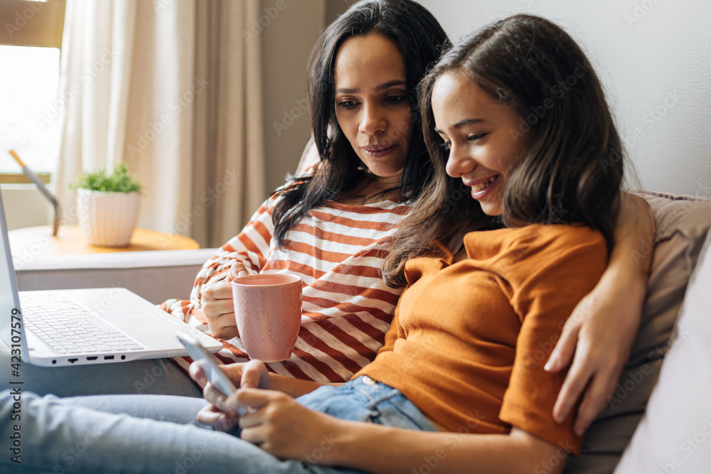 Single Mother Working From Home With Preteen Daughter Around Stock