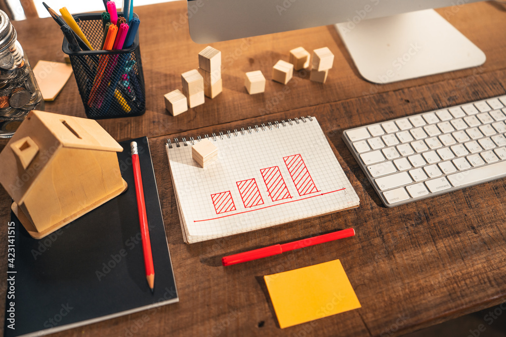 Drawing a graph of growth in a notebook on your desk at home. Stock ...