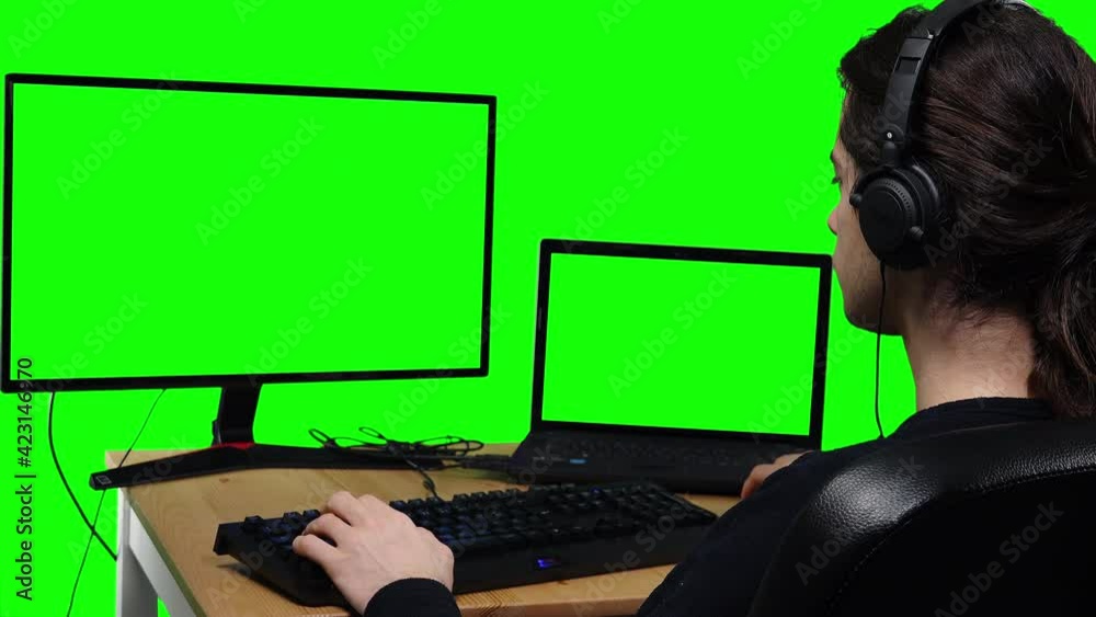 Using Multiscreen Computers Green Screen, Chroma Key Background. Young ...