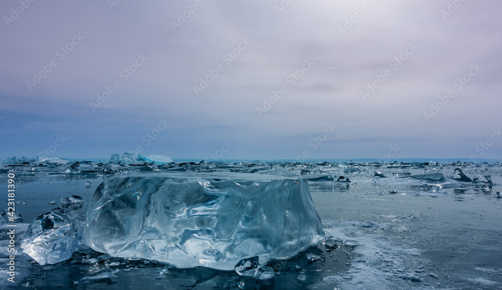 There are many pieces of ice scattered on the surface of the frozen ...