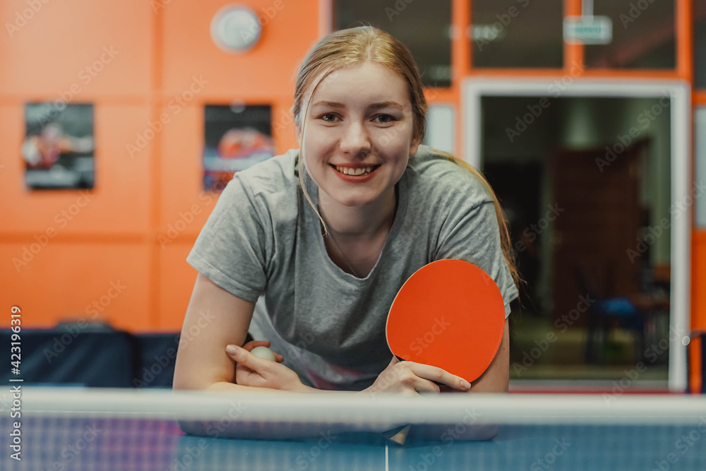 Portrait of a smiling teen girl table tennis player with a ping pong ...