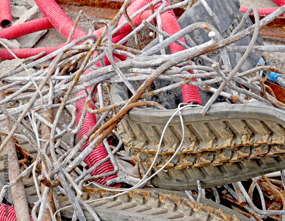 Scrap yard: rubber tracks, steel armor with rust and flexible hoses for ...