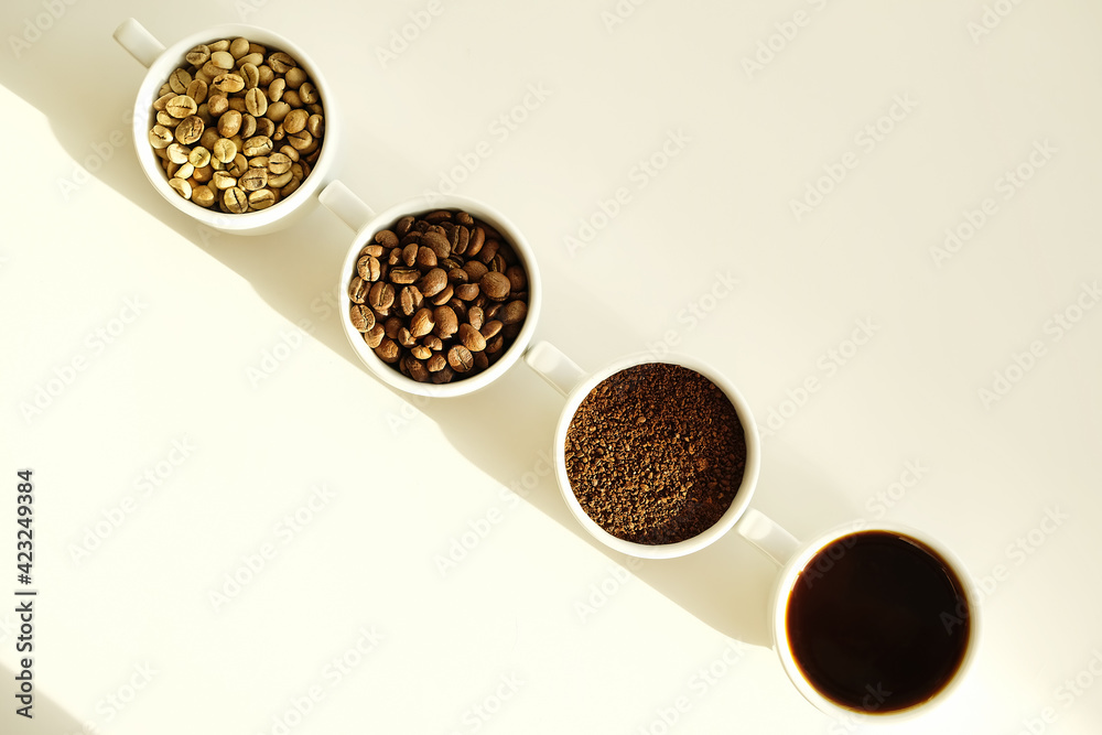Four stages: raw green, roasted, ground and brewed coffee. White ...