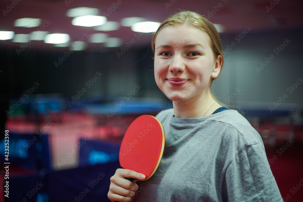Portrait of a smiling young girl table tennis player with a ping pong ...