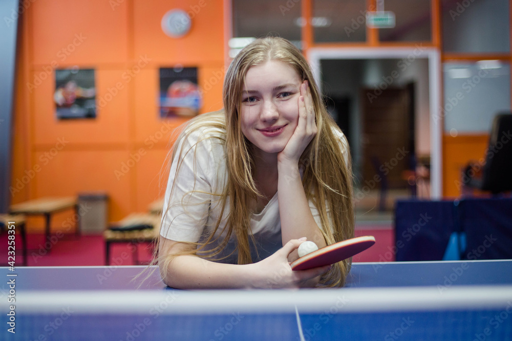 Portrait of a smiling teen girl table tennis player with a ping pong ...