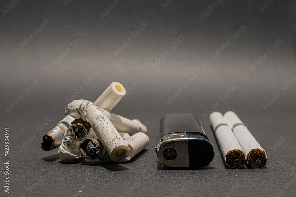 cigarette butts and lighter Stock Photo | Adobe Stock