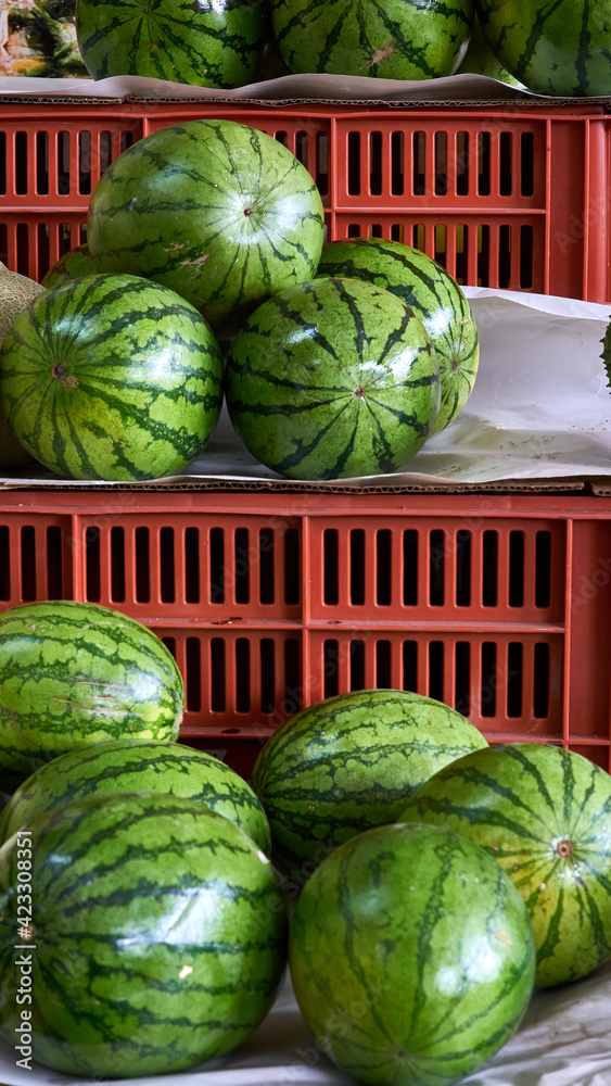 Selection of organic watermelons on display at the market stall ...