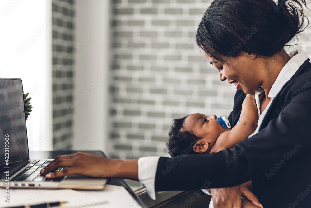 Portrait of african american black mother relaxing using technology of ...