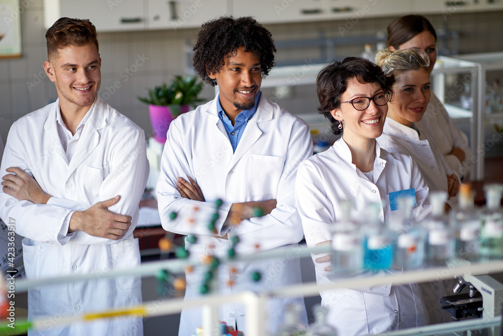 Young scientists posing for a photo in the laboratory. Science ...