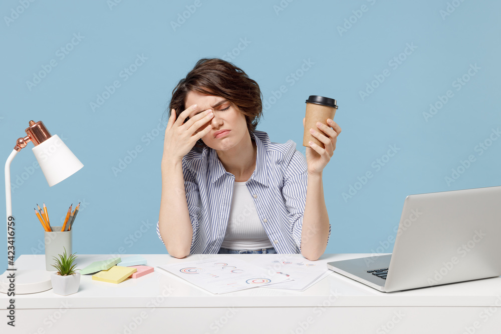 Young sleepy employee business woman in casual shirt sit work at white ...