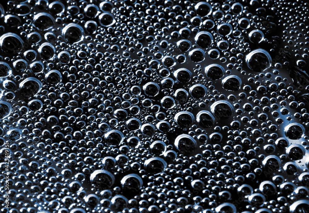 Drops of water on a black surface. The condensate. Top view. Free space ...