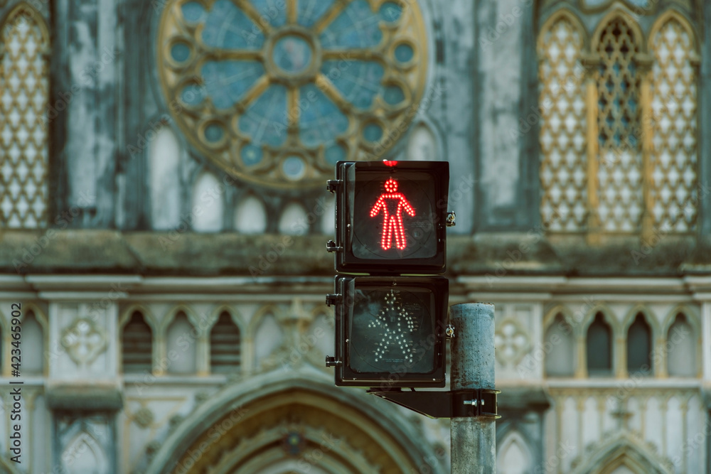 Pedestrian traffic light signaling red. In the background, construction ...