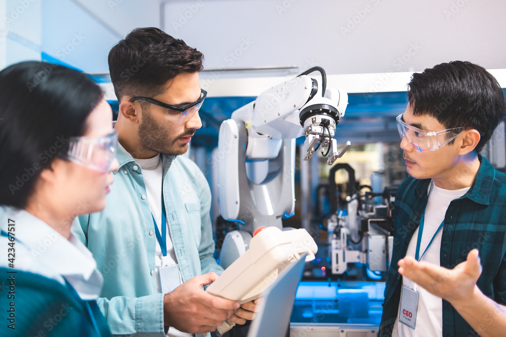Male Engineers Maintenance Robot Arm at Lab. he are in a High Tech ...