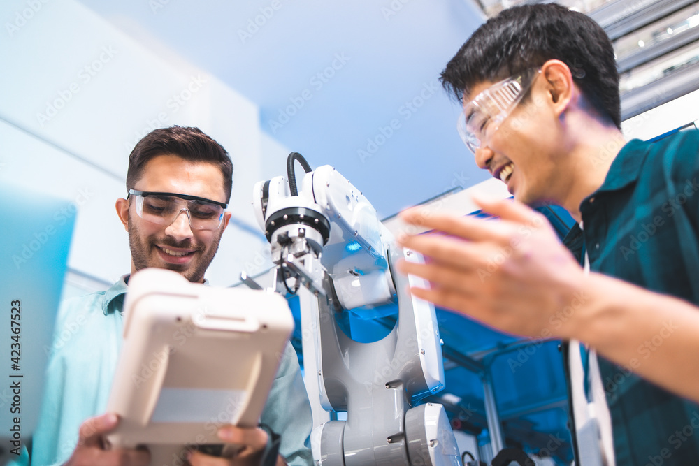 Male Engineers Maintenance Robot Arm at Lab. he are in a High Tech ...
