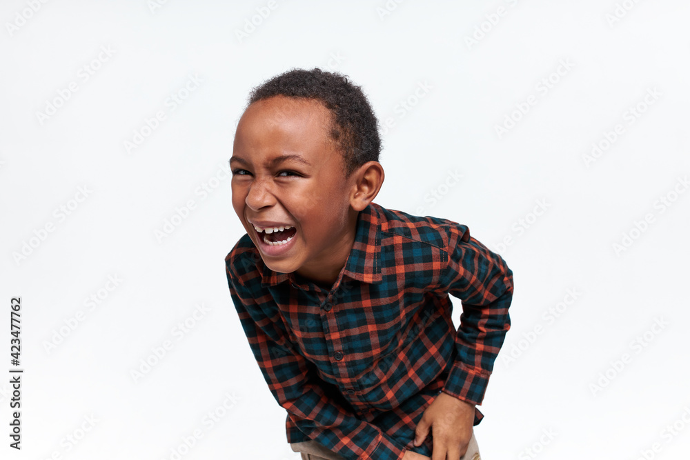 Portrait of emotional overjoyed Afro American little boy in plaid shirt ...