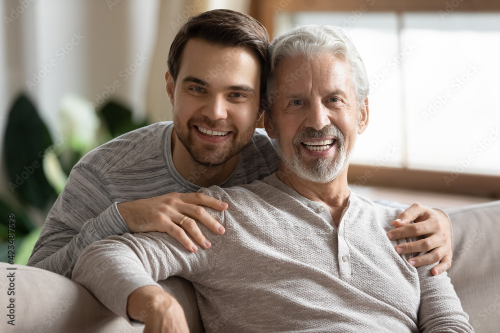 Portrait of smiling millennial Caucasian man feel grateful pose hug ...