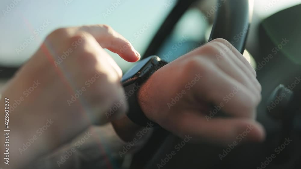 Close-up male hands using modern smart watch in car. Man watch ...