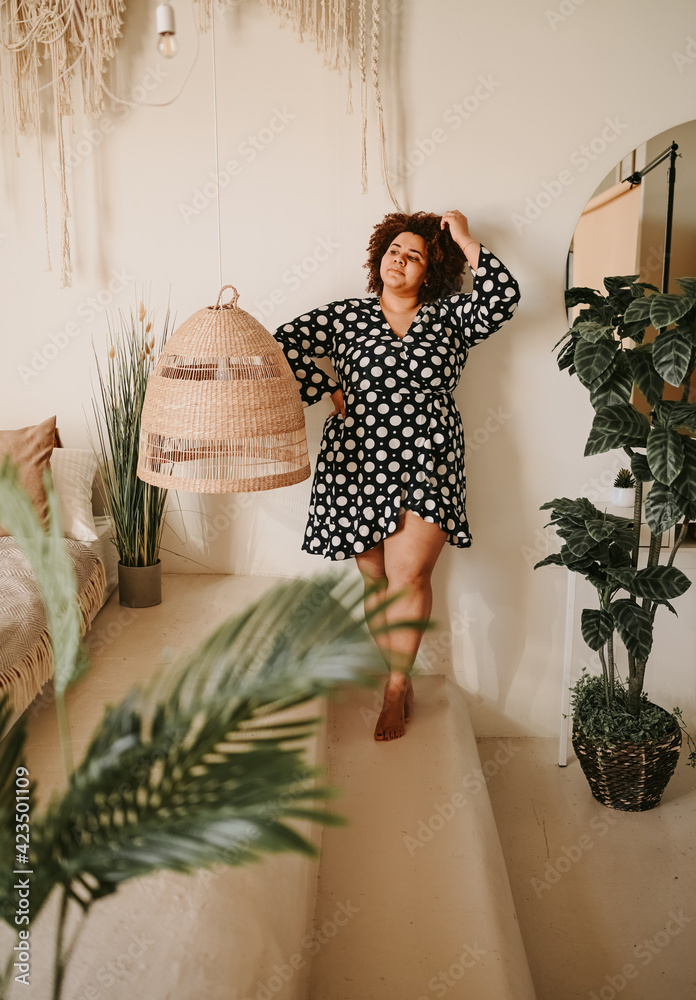 Curvy oversize African black woman afro hair in dress polka dot in eco ...